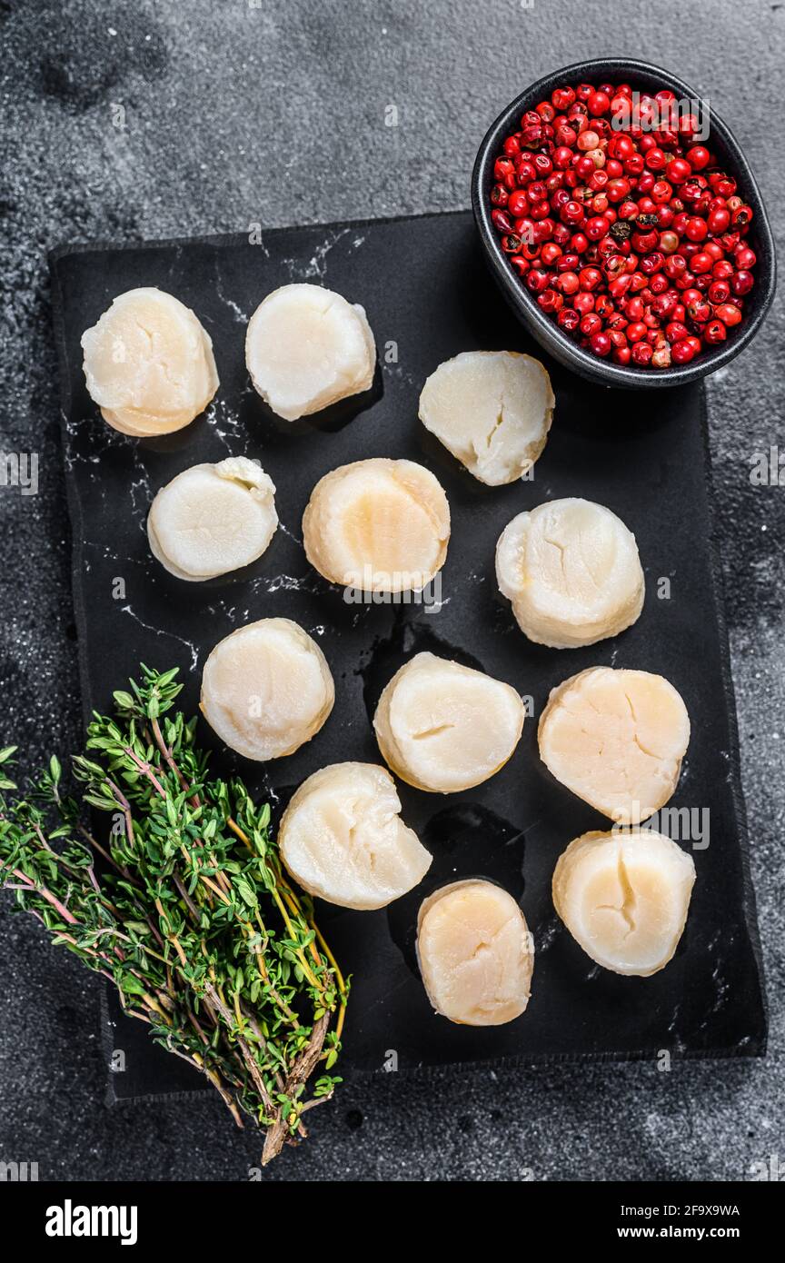 Seafood fresh scallops meat on a marble board. Black background. Top ...