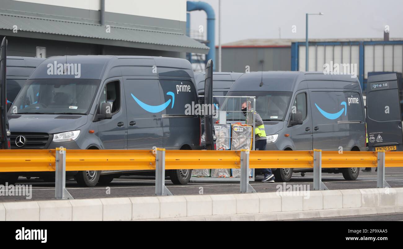 Electric delivery vans are packed at the Amazon warehouse in the ...