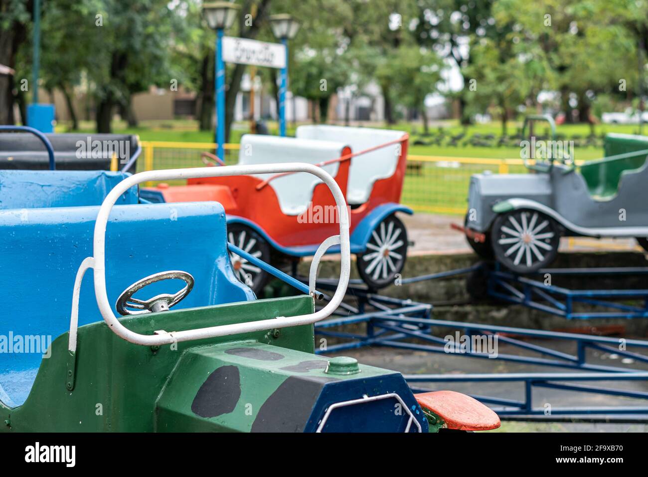 Colorful cars of the merry-go-round carousel in the amusement park ...