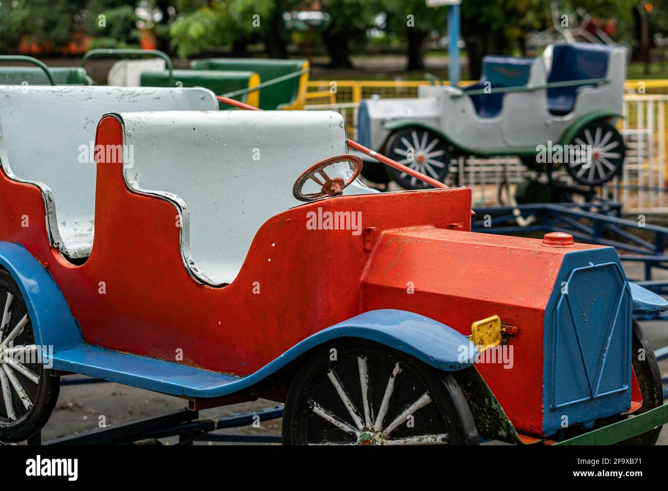 Colorful cars of the merry-go-round carousel in the amusement park ...