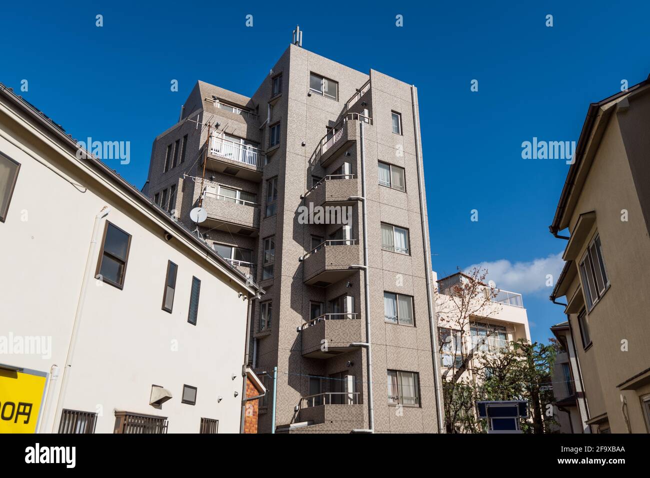 Tokyo, Japan - December 11, 2015: Apartment buildings on city street ...