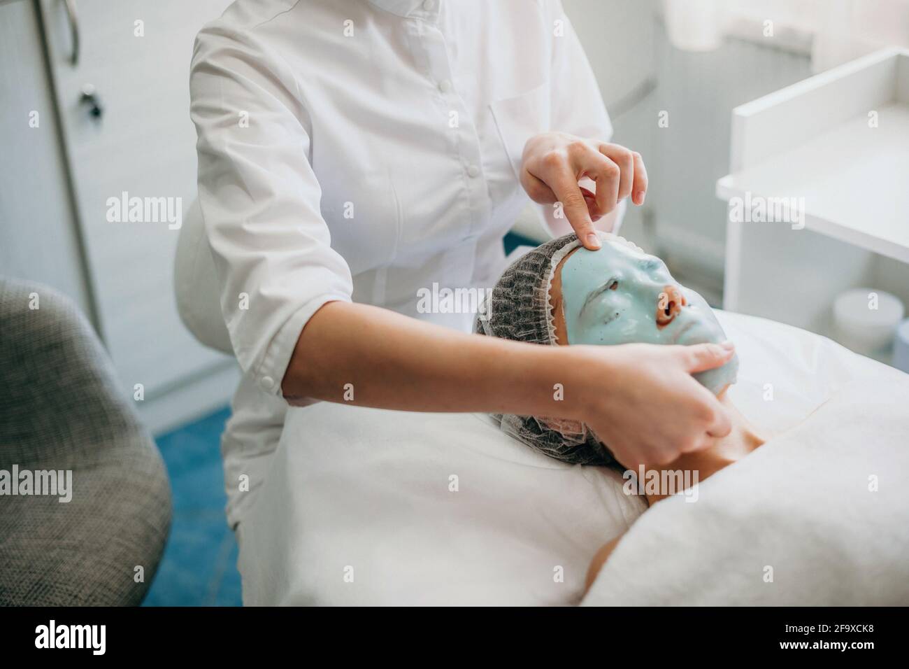 Caucasian woman is wearing a mask on face during spa procedures at a ...