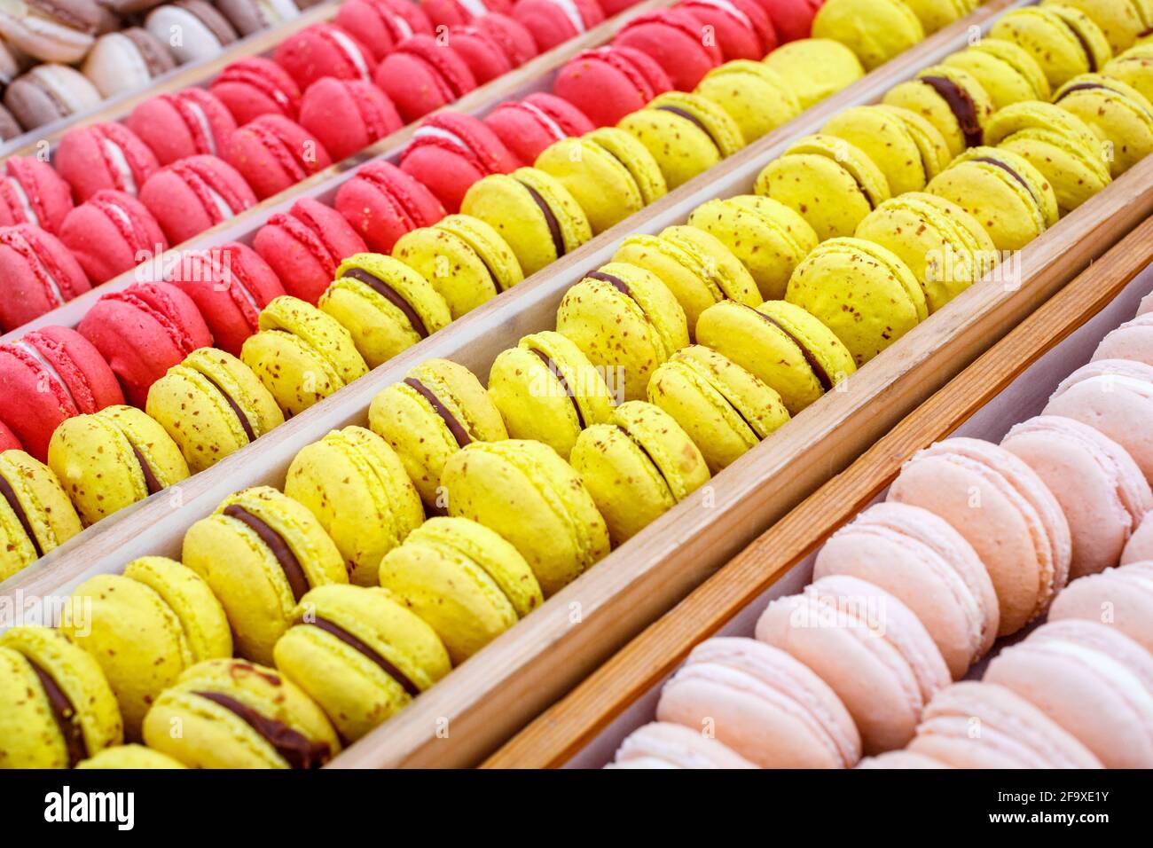 Colorful french macarons in wooden trays, close up. Different colorful ...