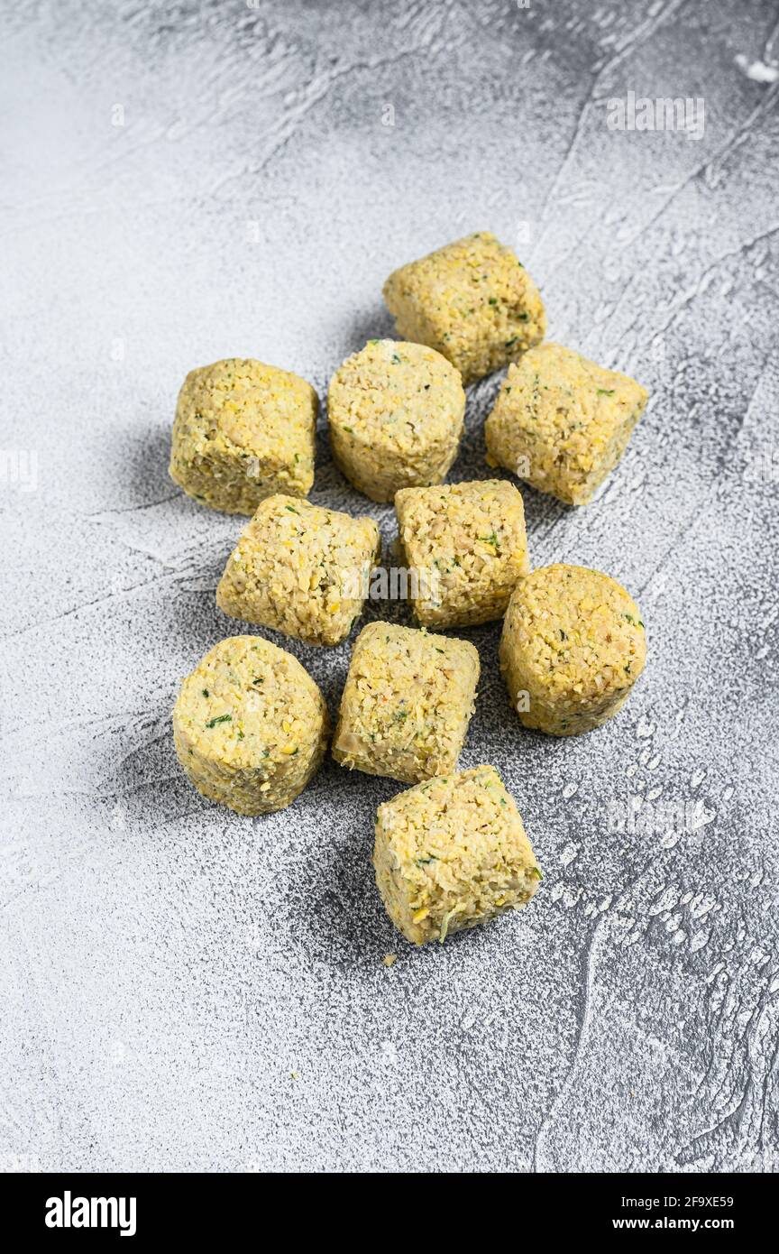 Raw falafel balls on a kitchen table. White background. Top view Stock ...