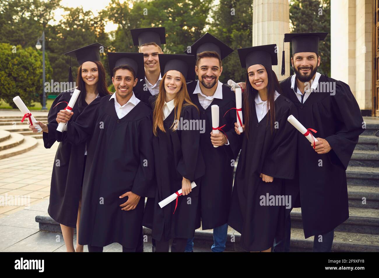 A group of young female graduates. Female graduate is smiling against ...
