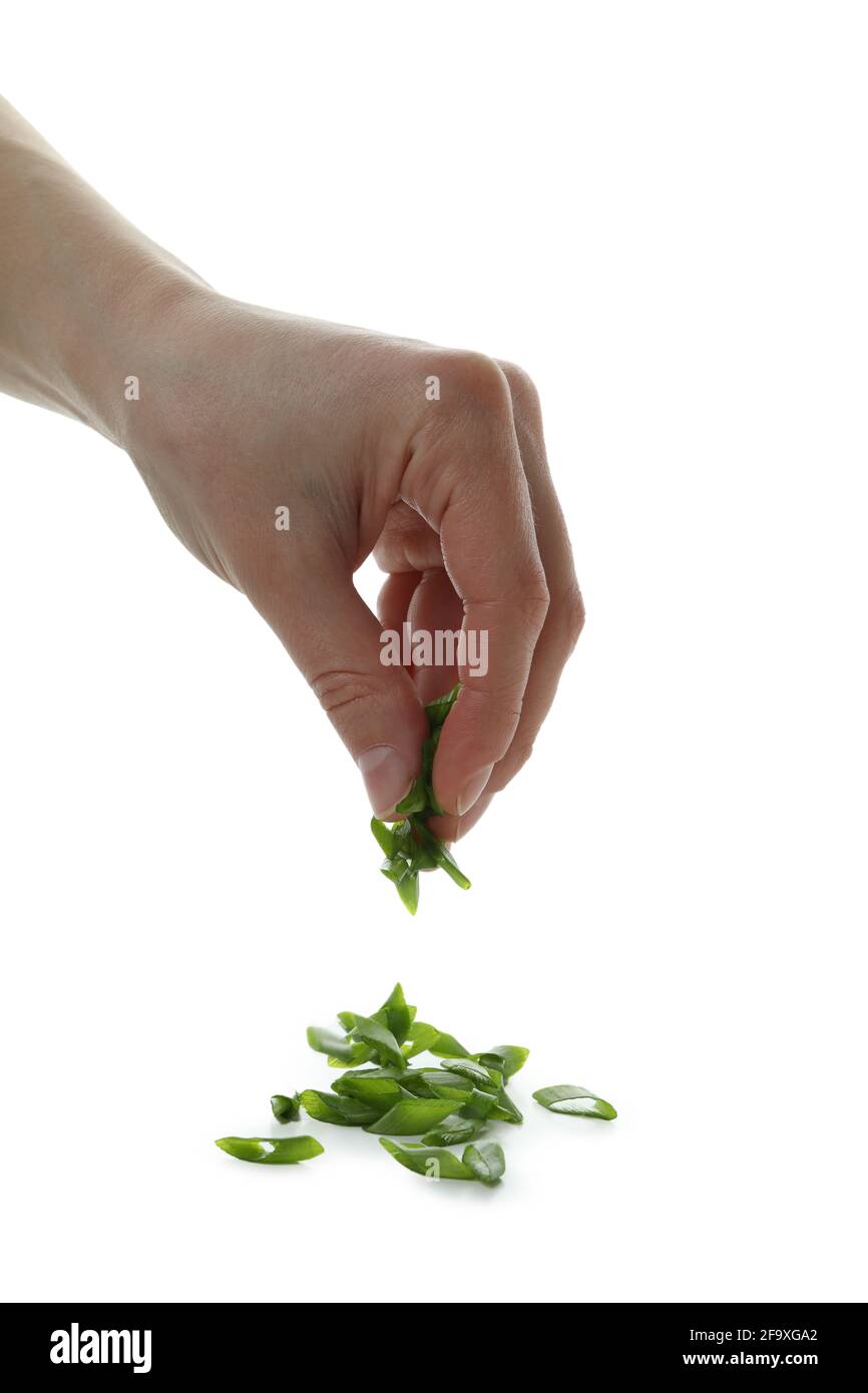 Female hand sprinkle chopped green onion, isolated on white background ...