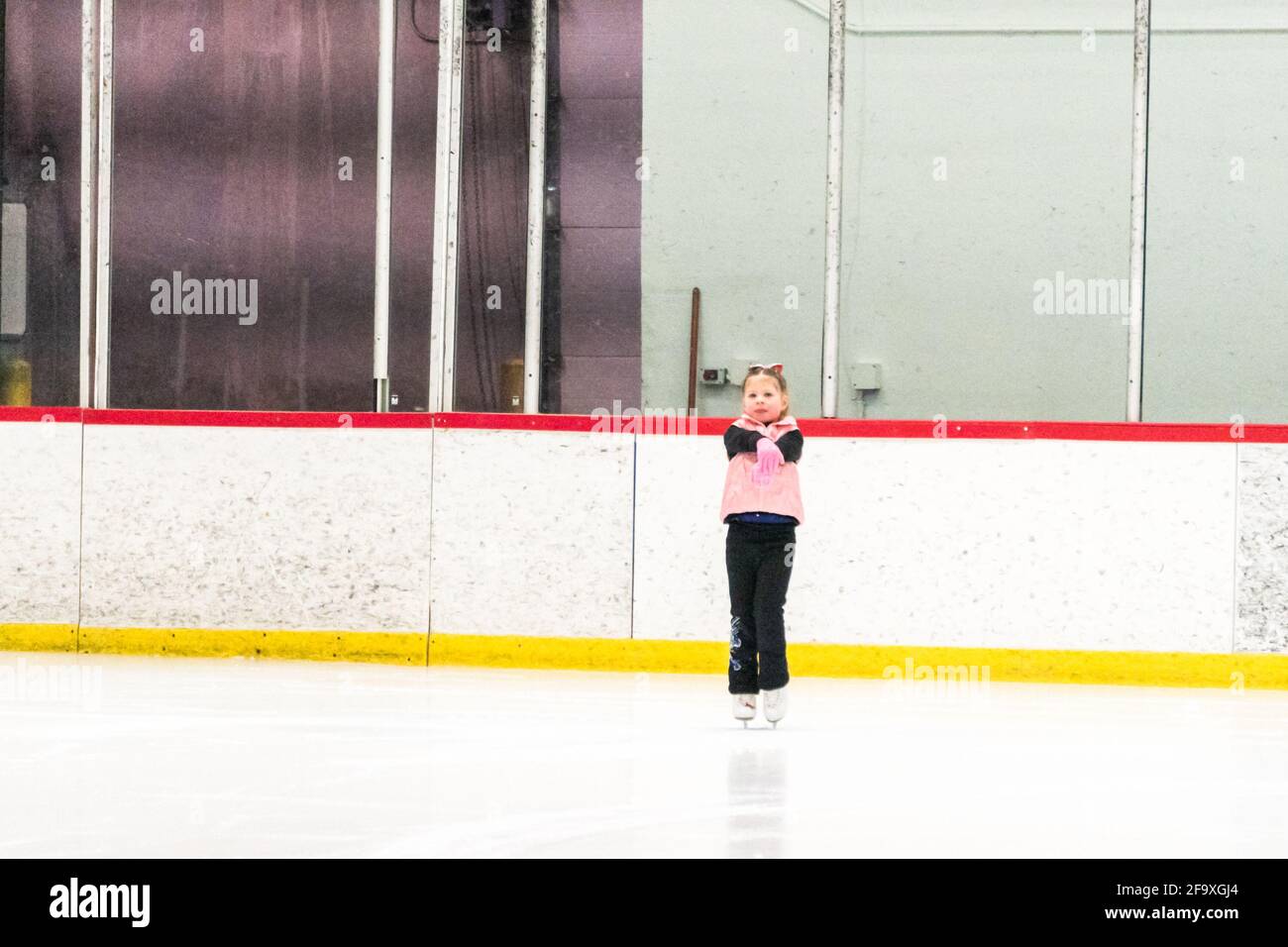Little skater practicing her elements at the morning figure skating ...