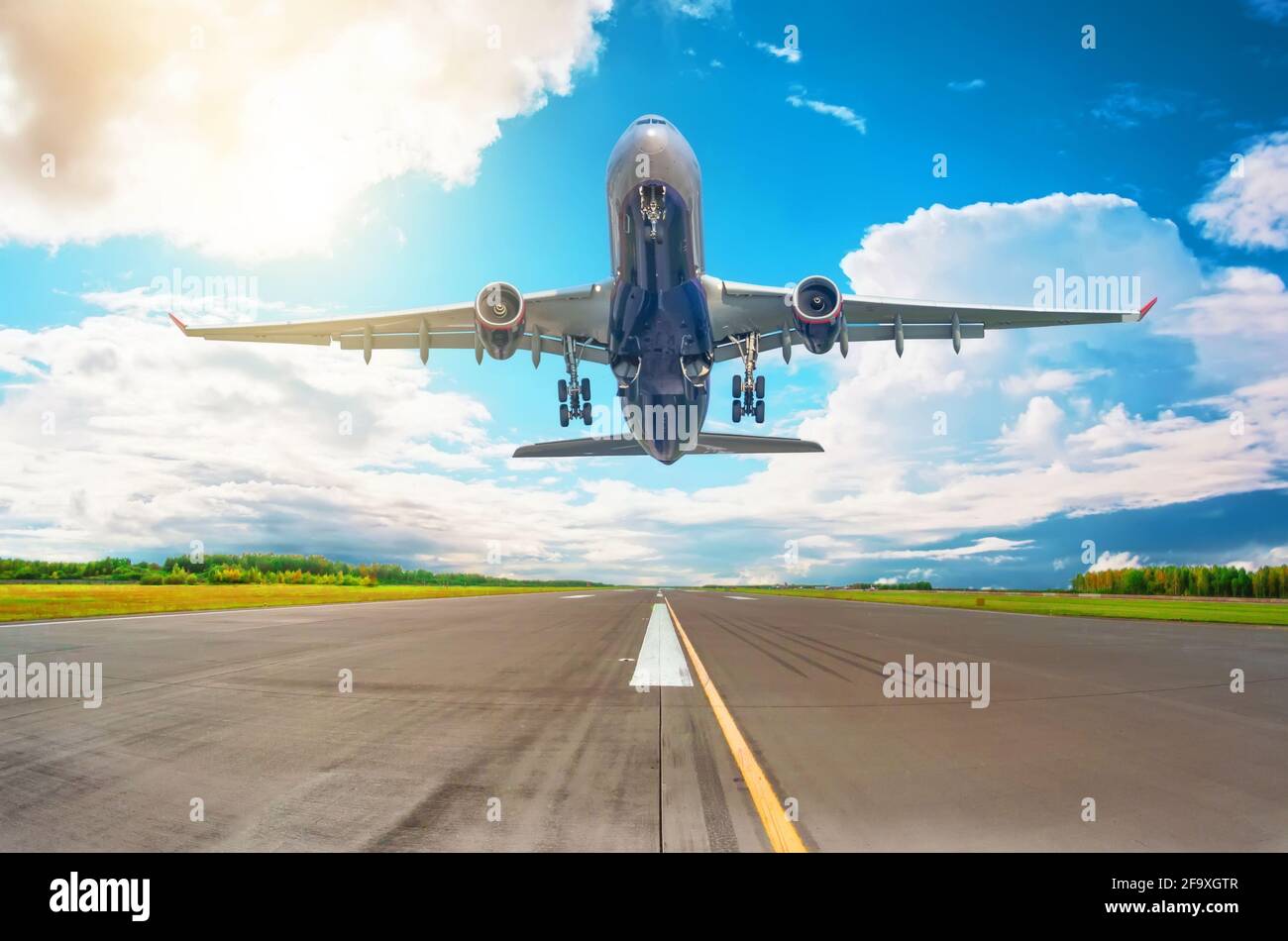 Rapidly plane taking off runway, airstrip with marking on blue sky with ...