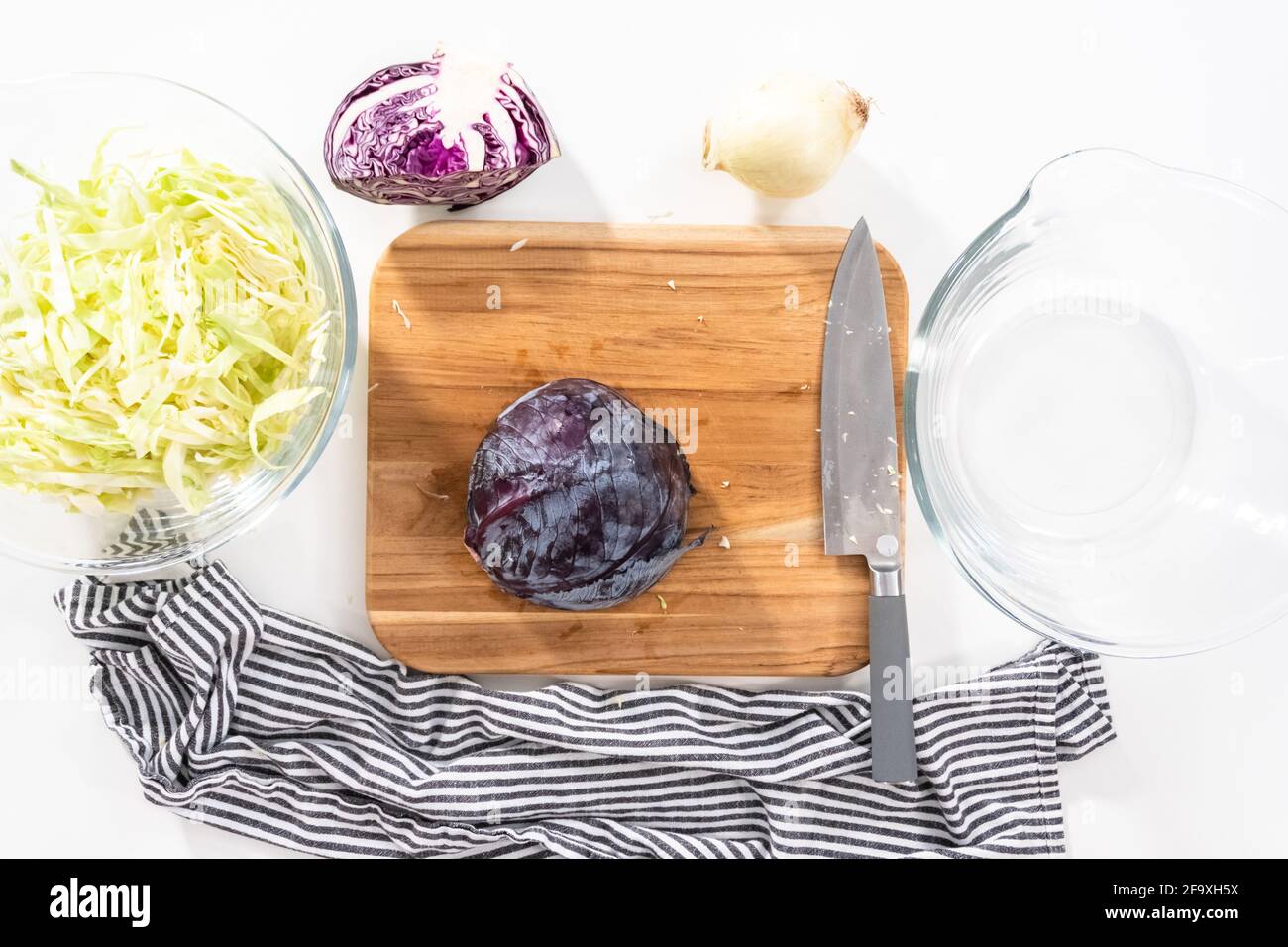 Flat lay. Shredding green cabbage on a wood cutting board Stock Photo ...