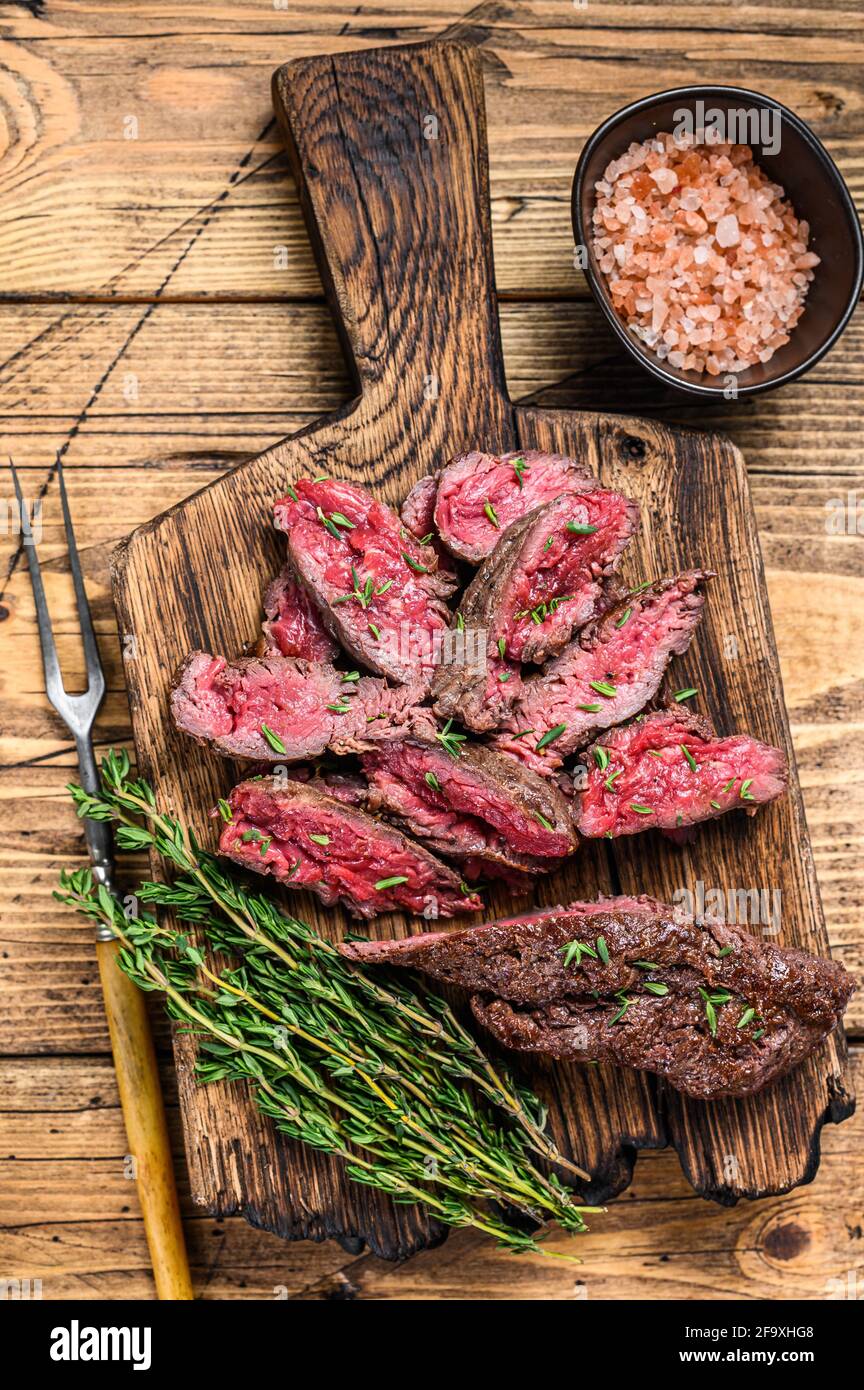 Sliced grilled machete skirt meat beef steak on a wooden cutting board ...