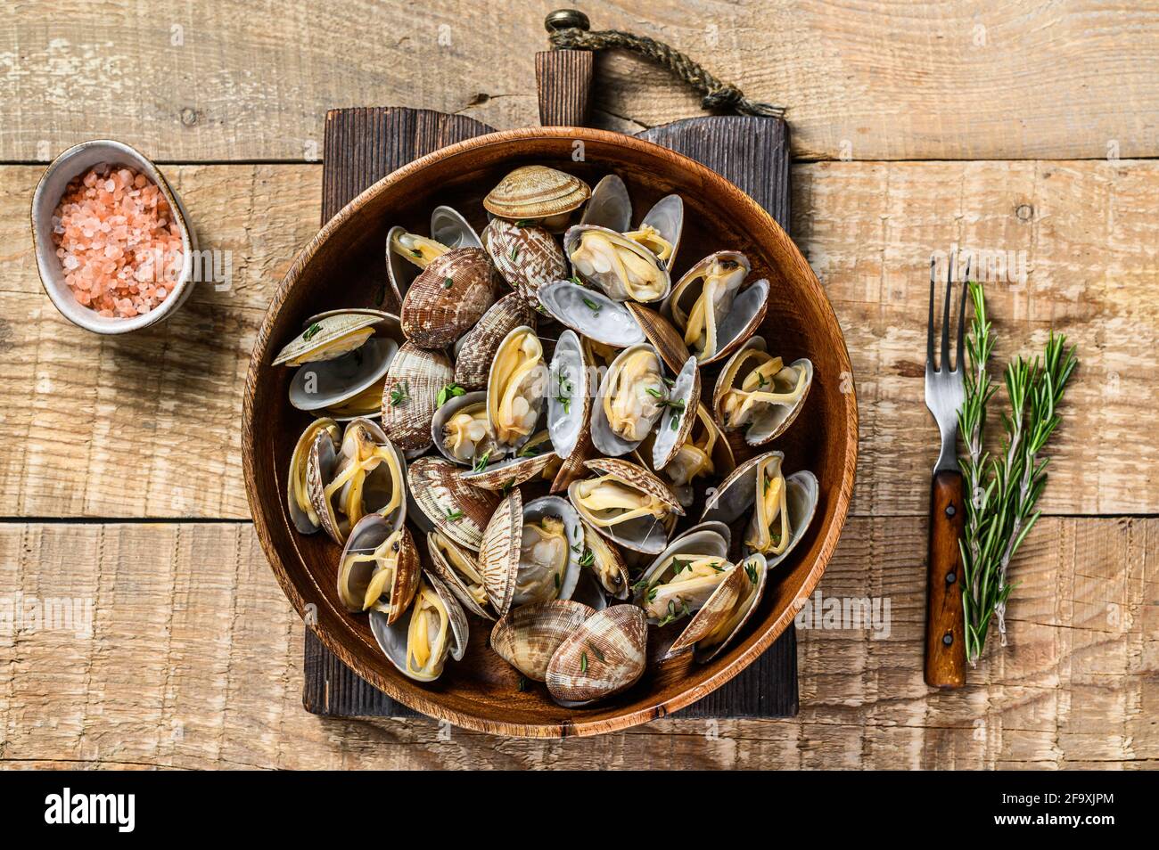 Steamed cooked shells Clams vongole in a wooden plate. wooden ...