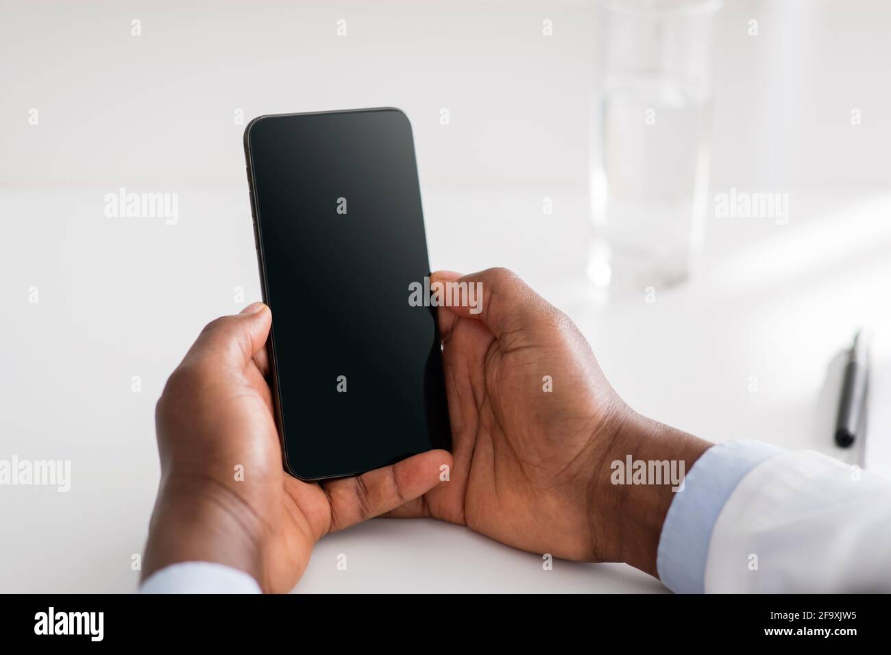 Online doctor and remote advice. Black male doctor using smartphone ...