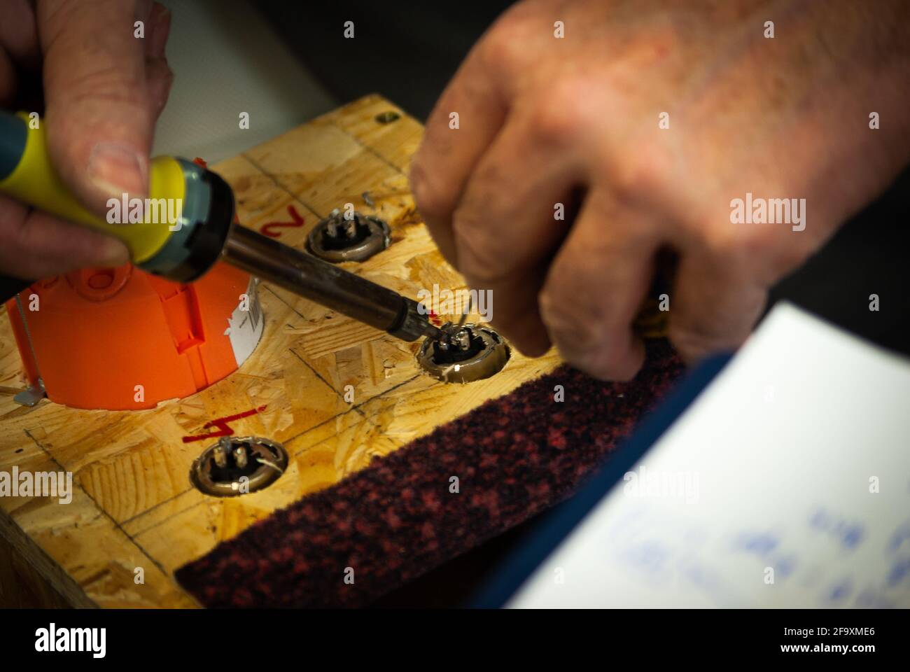 Hands of a man soldering cables to audio connector sockets Stock Photo ...