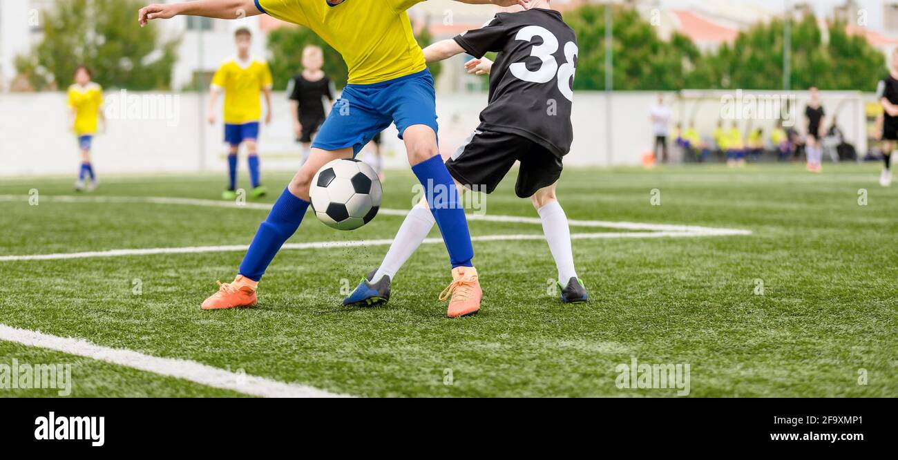 Football Kids Playing Game. Two Players in Opposing Teams in a Duel ...