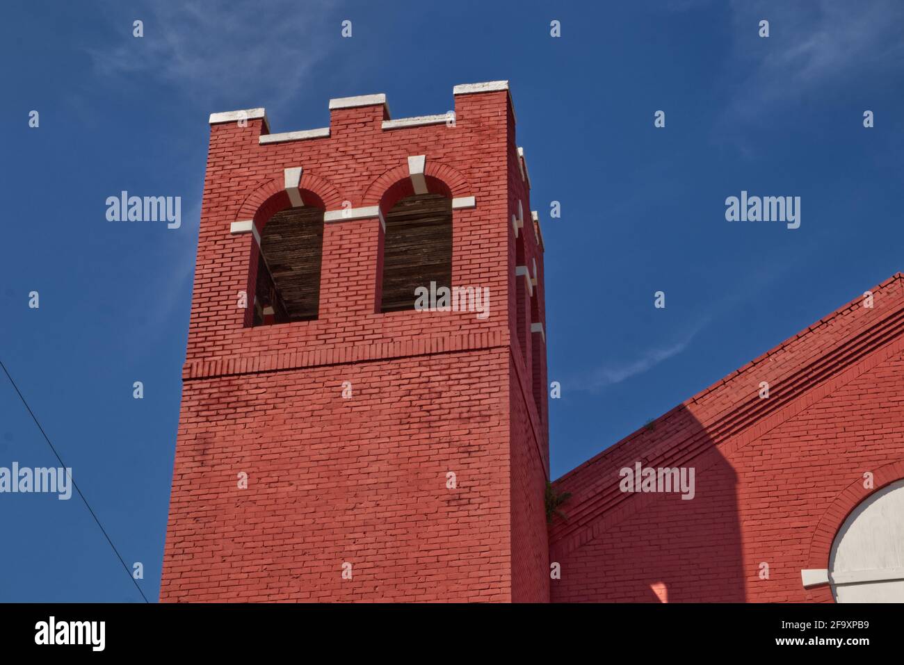 Red brick tower with window openings blue sky old rustic building ...