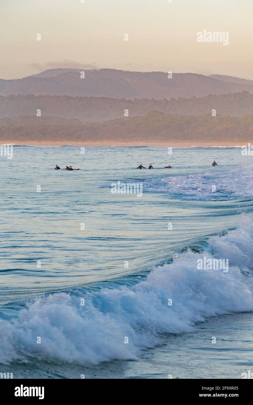 Board riders sitting in the surf hi-res stock photography and images ...