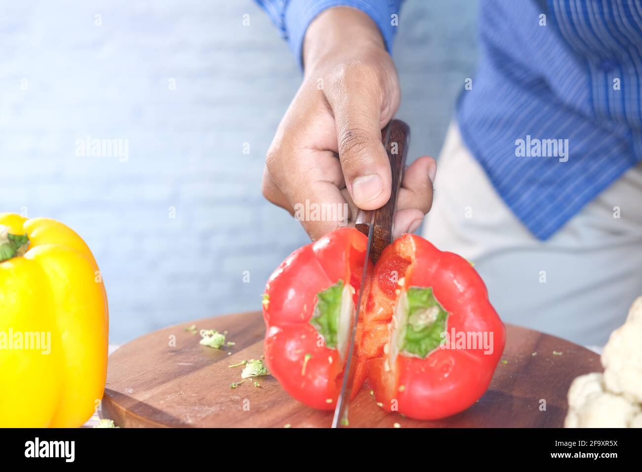 cutting red capsicum on chopping background Stock Photo - Alamy