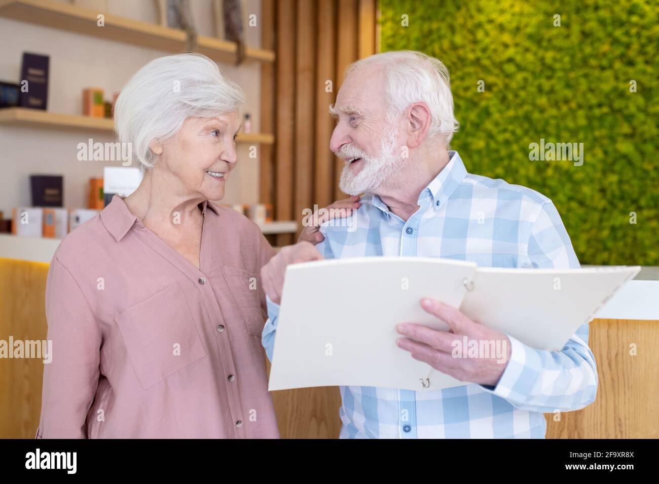 Elderly couple choosing procedures in a spa center Stock Photo - Alamy