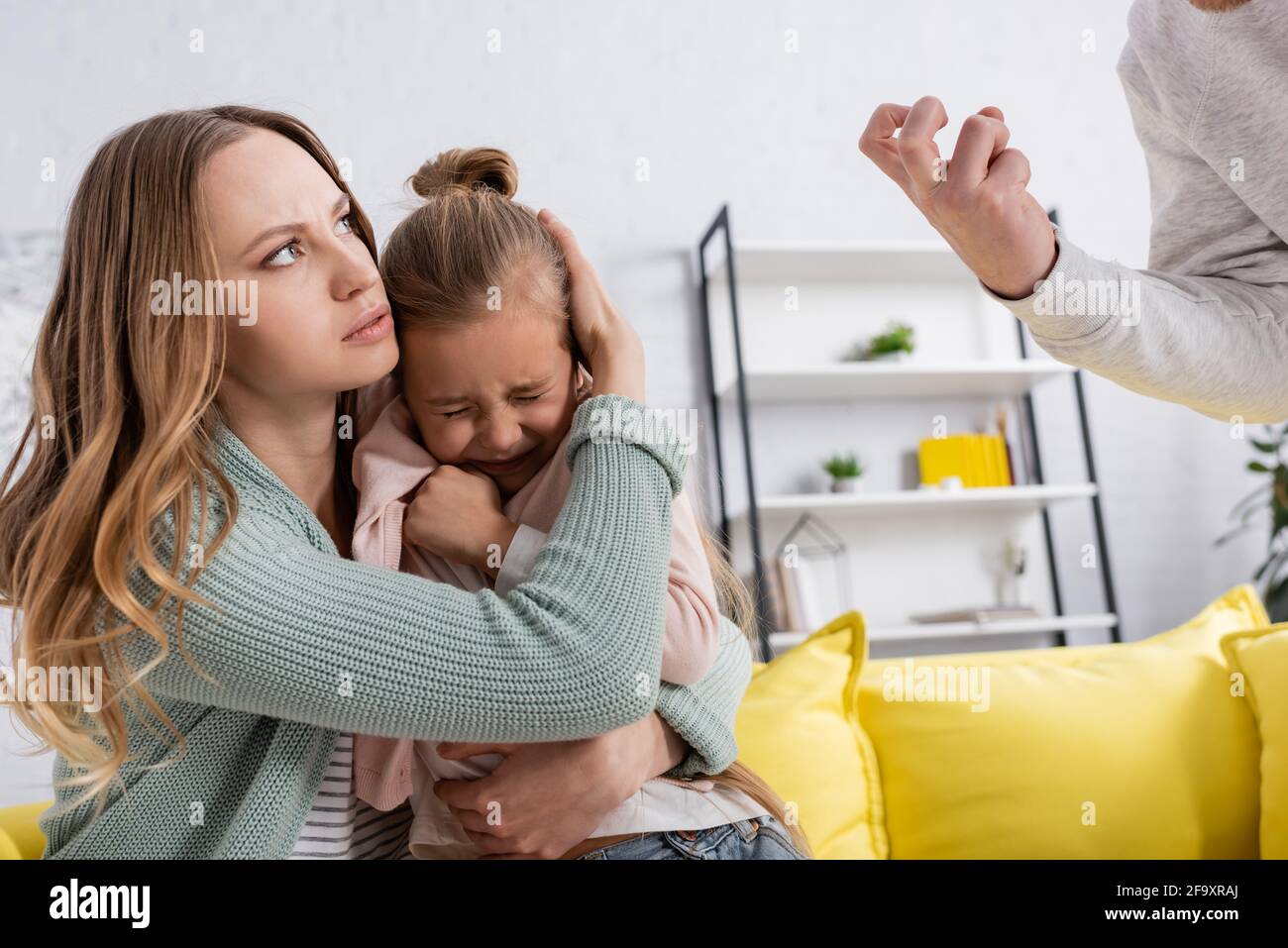 Angry man standing near scared kid and wife Stock Photo - Alamy