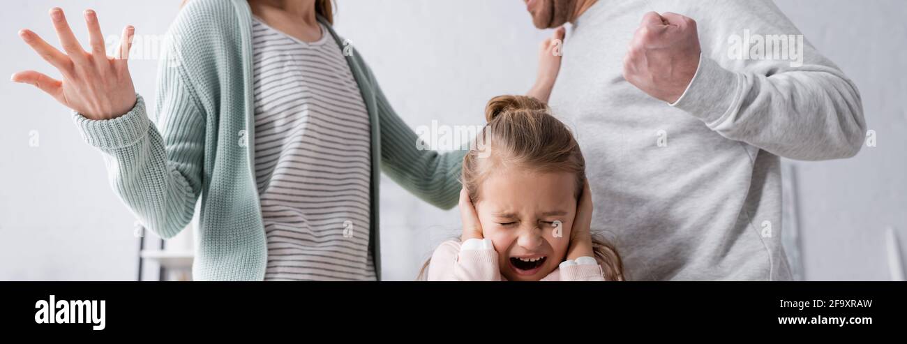 Screaming kid between parents quarrelling at home, banner Stock Photo ...