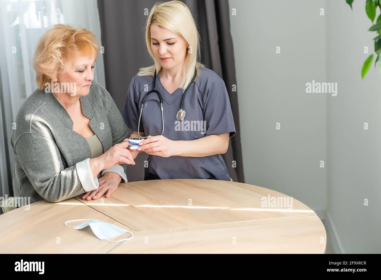 Medic and patient using finger pulse oximeter Stock Photo - Alamy