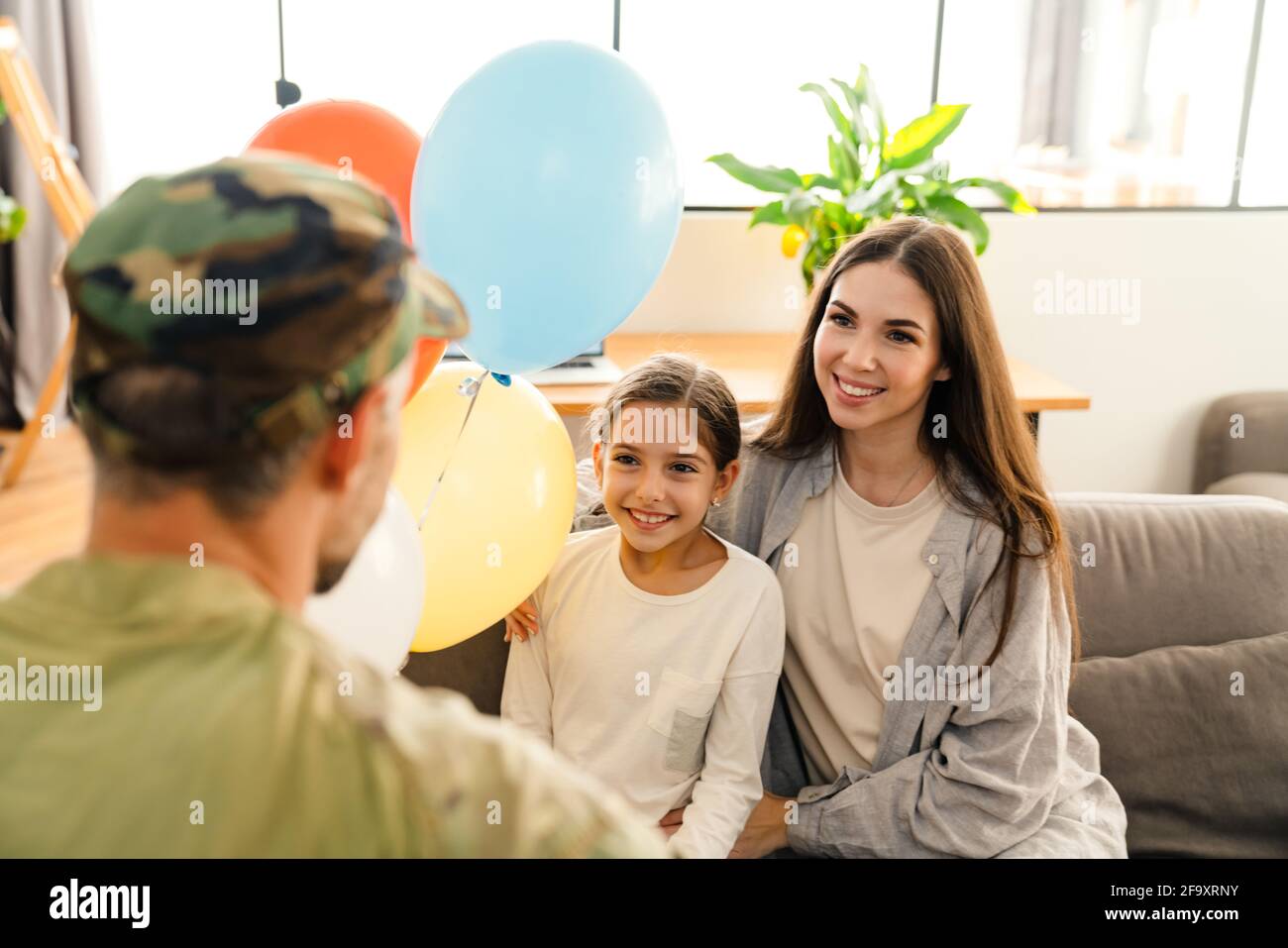 Happy kids and their mom meeting military dad in uniform indoors ...