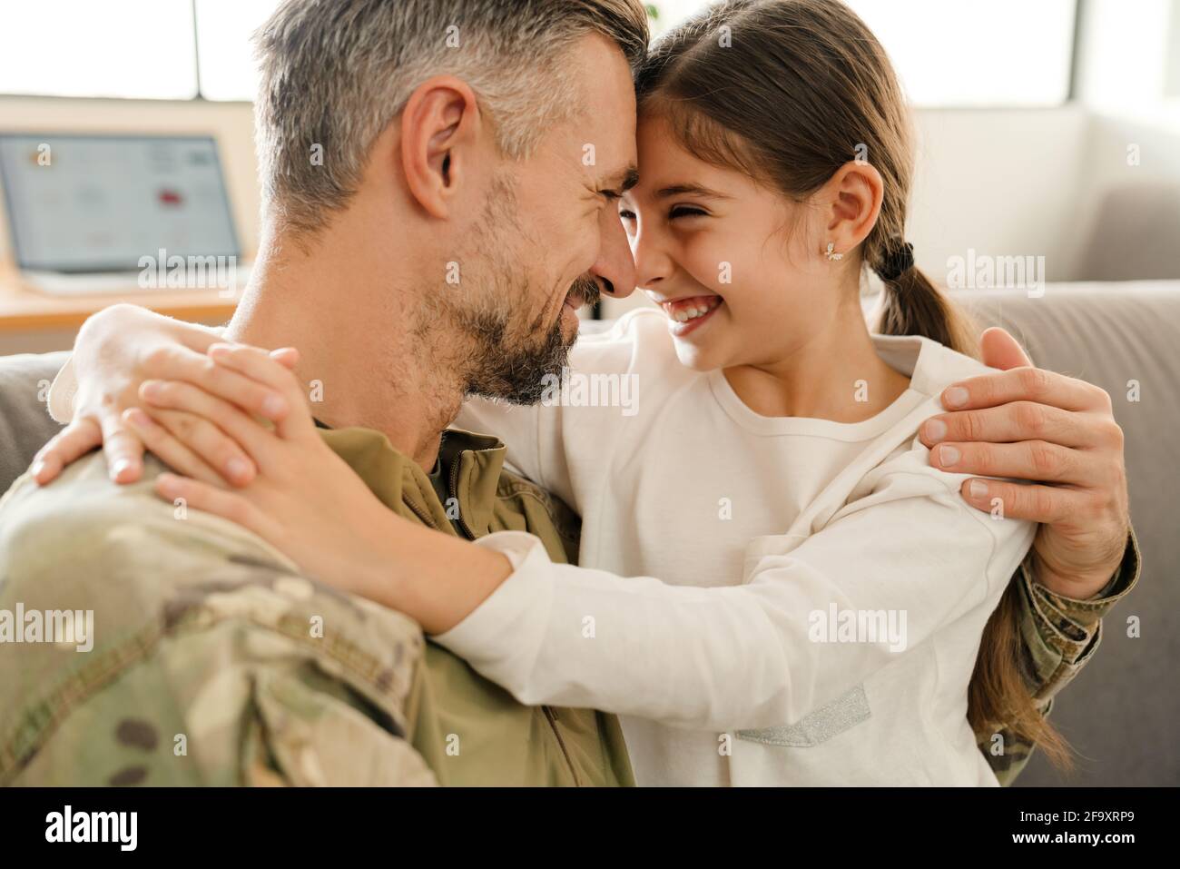 Happy military father and his daughter reunion at home. Family reunion ...