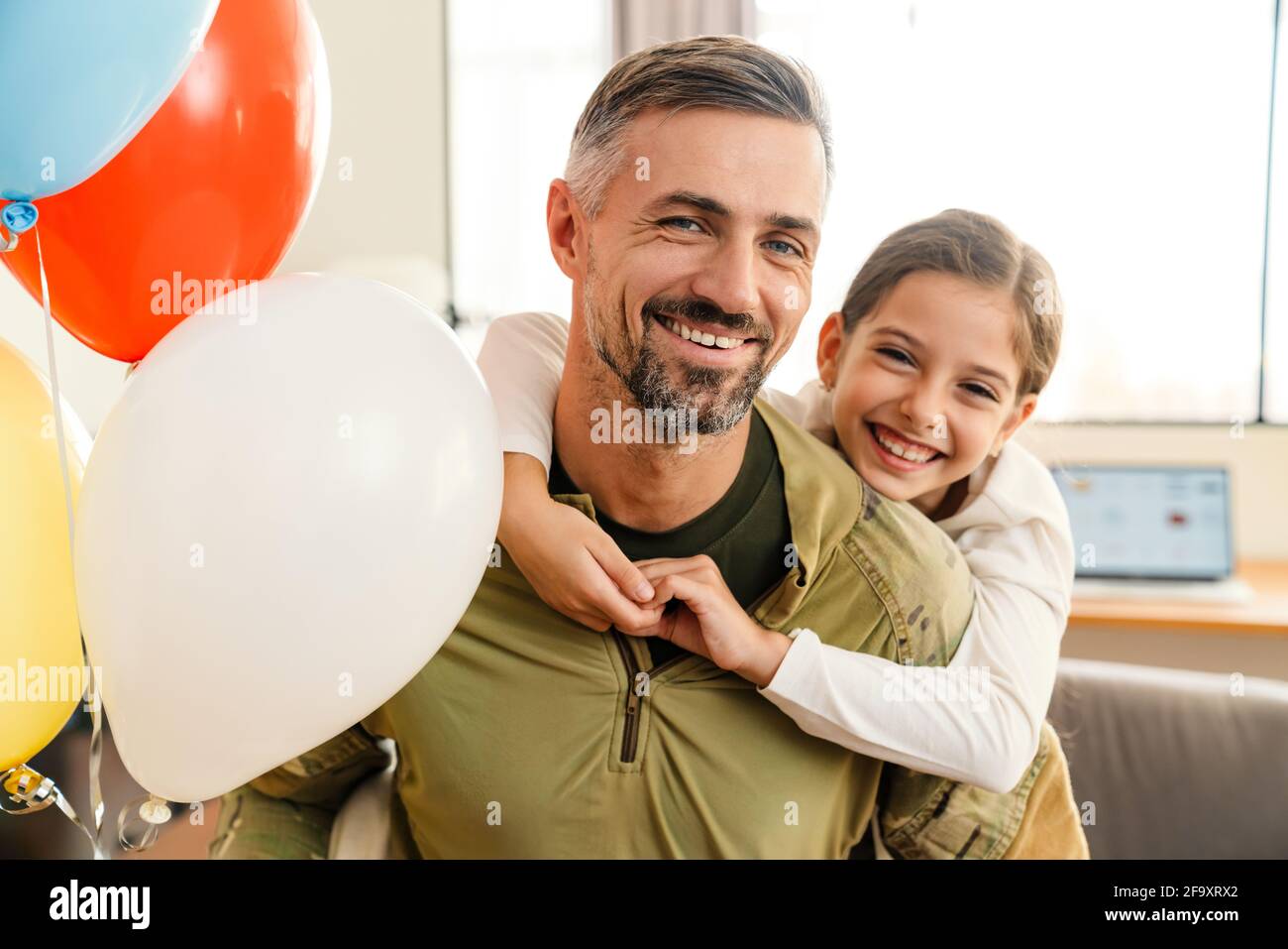 Happy military father and his daughter reunion at home. Family reunion ...