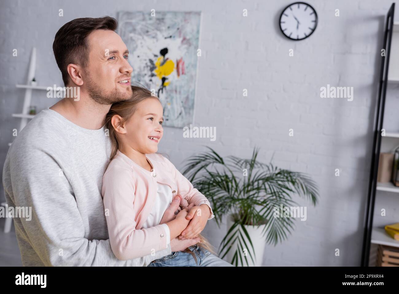 Happy father hugging child in living room Stock Photo - Alamy