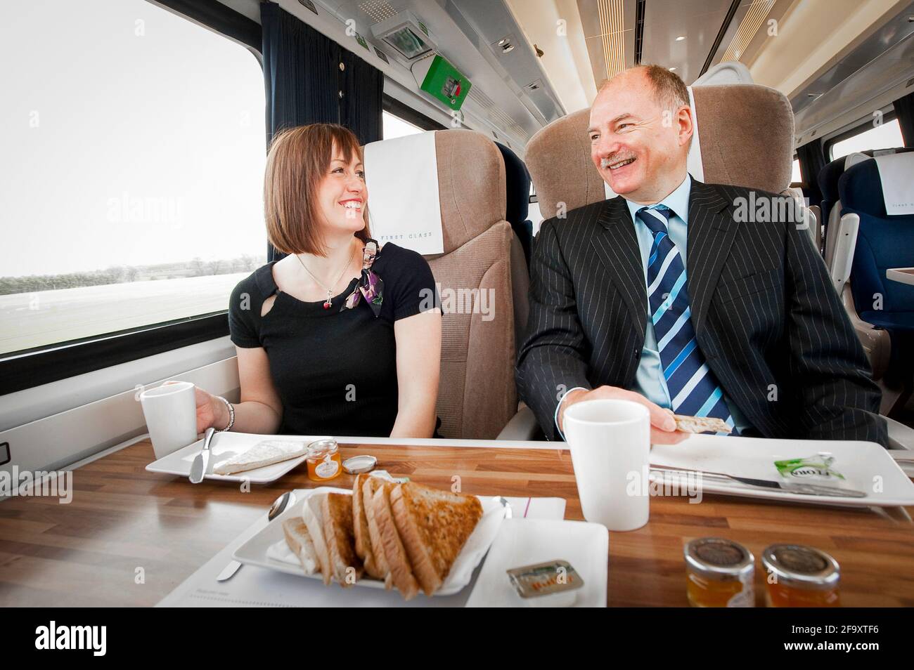 Man and woman enjoying breakfast in a first class carriage on a train ...