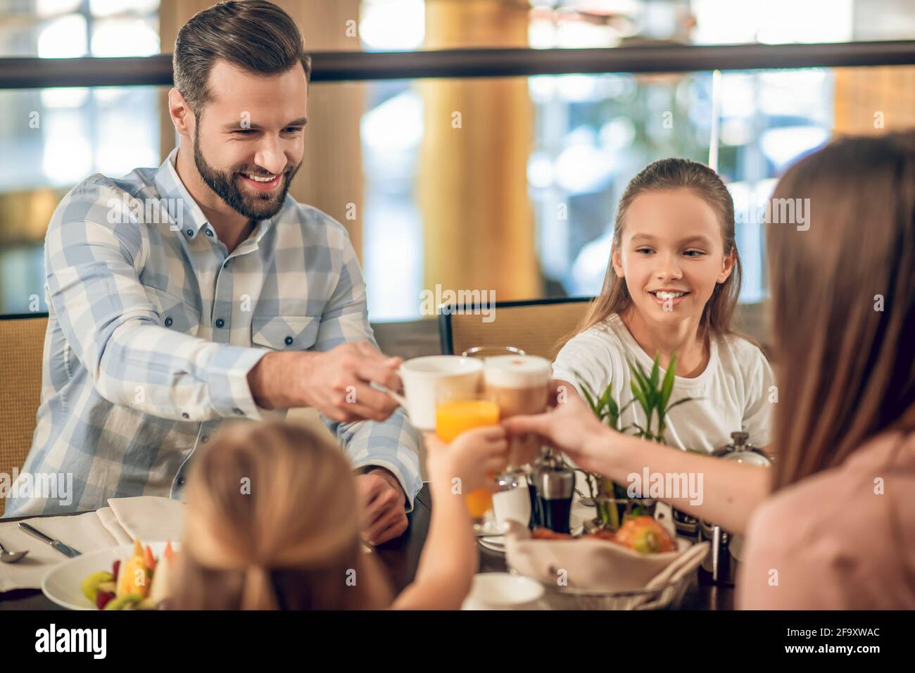 Happy family having breakfast together and looking excited Stock Photo ...