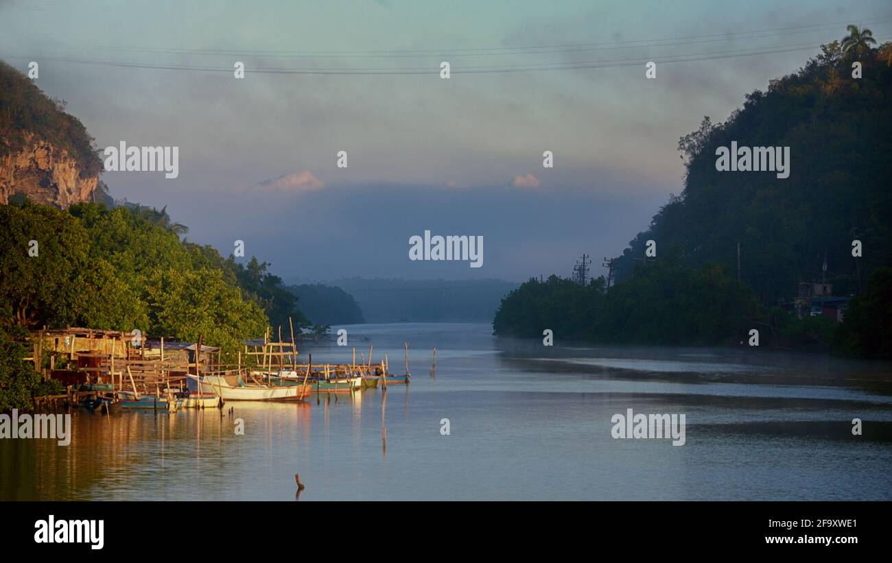 Yumuri river in Matanzas, Cuba with calm water, gentle sky and tall ...