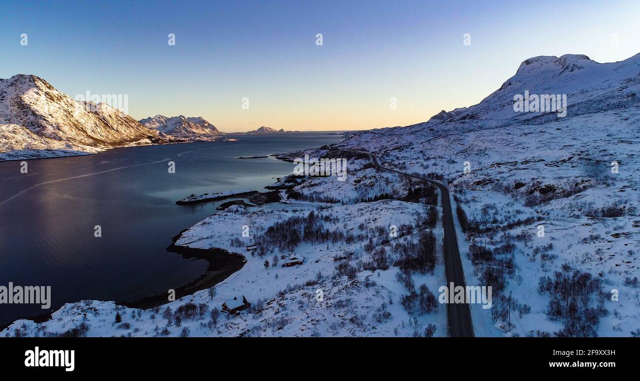Coastal road, in middle of snowy mountains 02 Stock Photo - Alamy