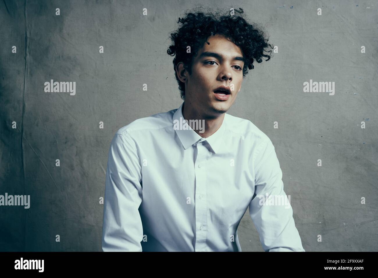 cute guy curly hair white shirt cropped look modern style Stock Photo ...