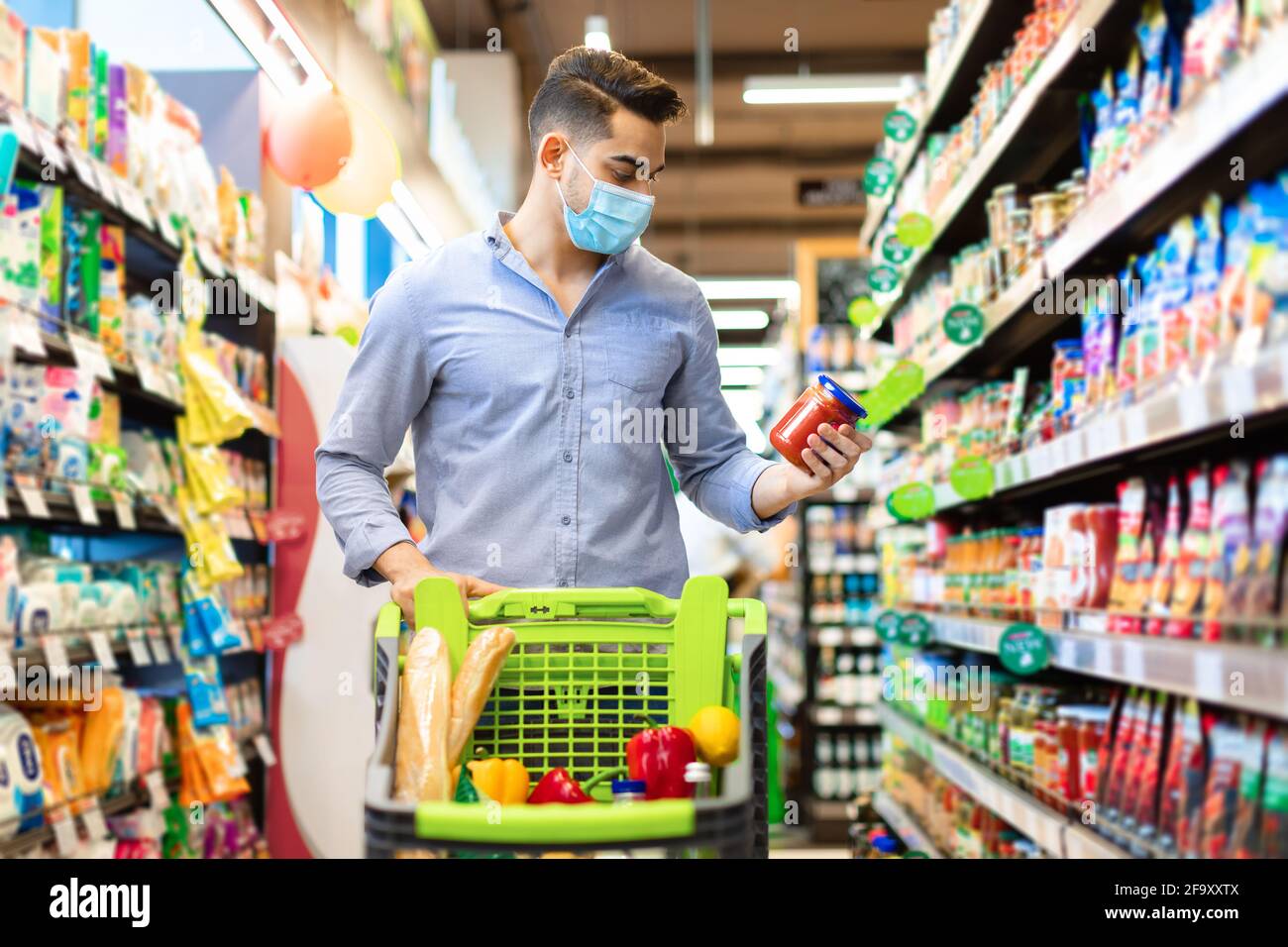 Arabic Male With Shopping Cart Choosing Groceries In Food Store Stock ...
