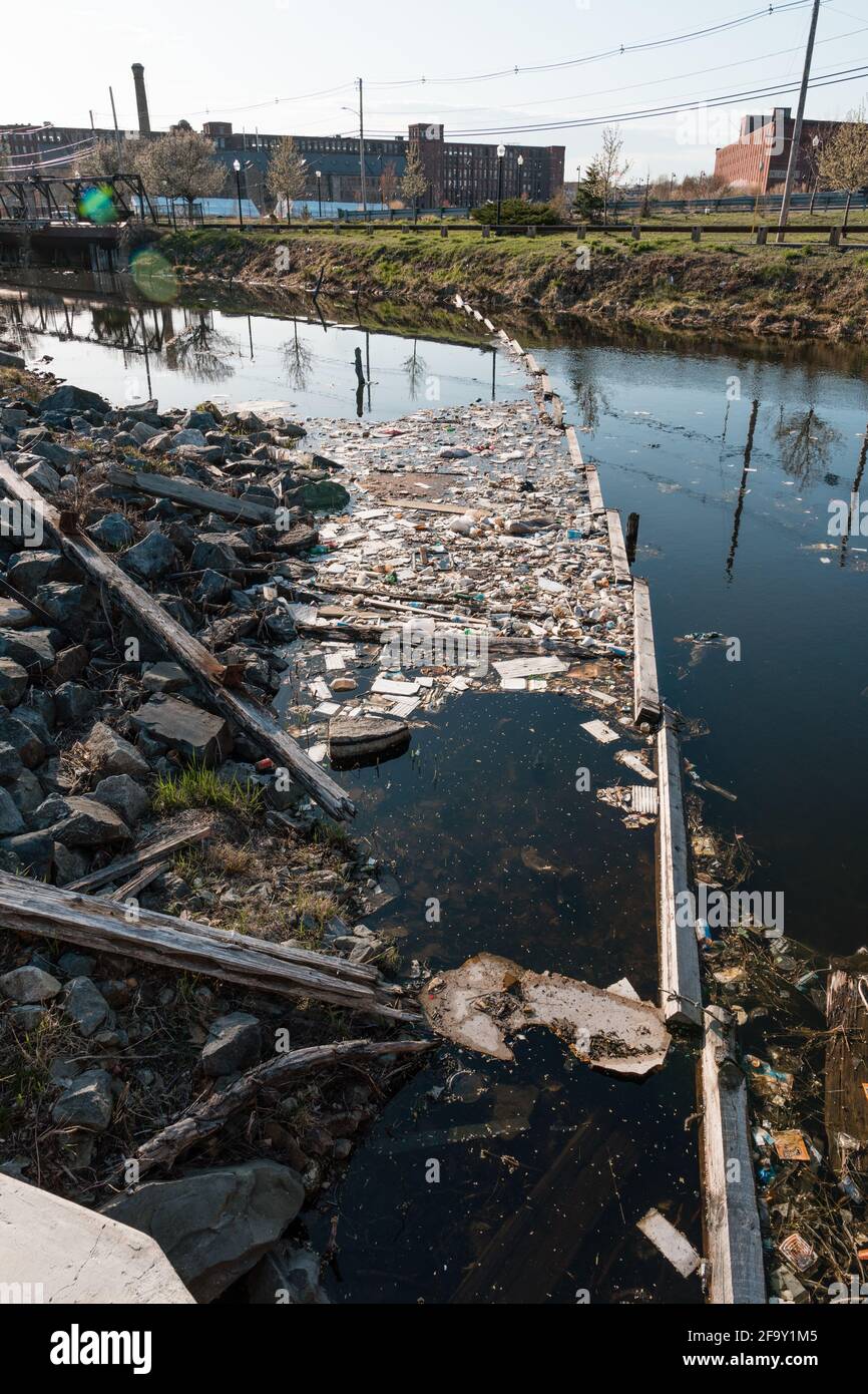 Garbage and trash collects in urban river causing a back up of ...