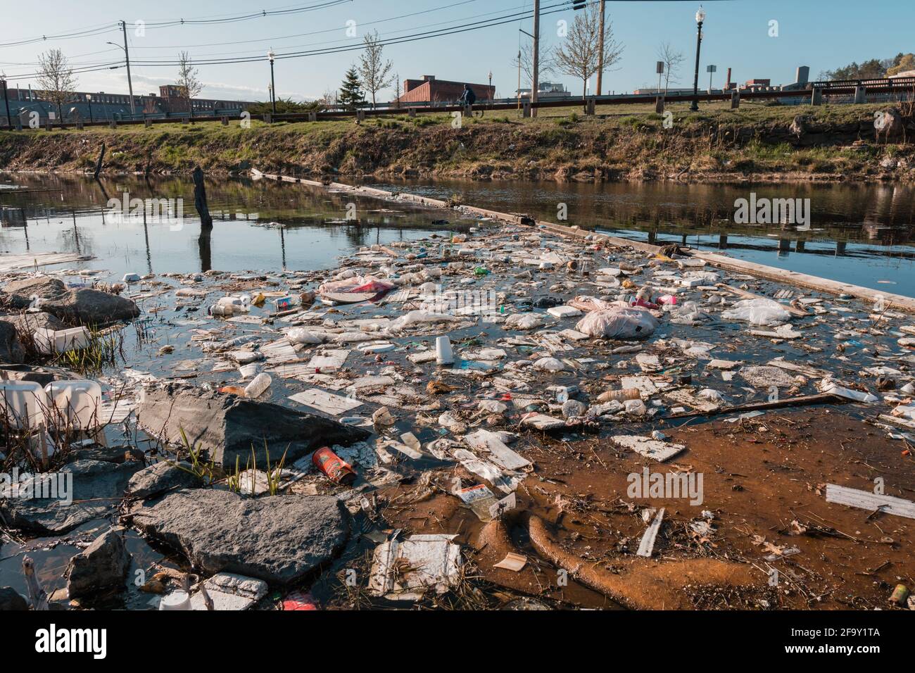 Garbage and trash collects in urban river causing a back up of ...