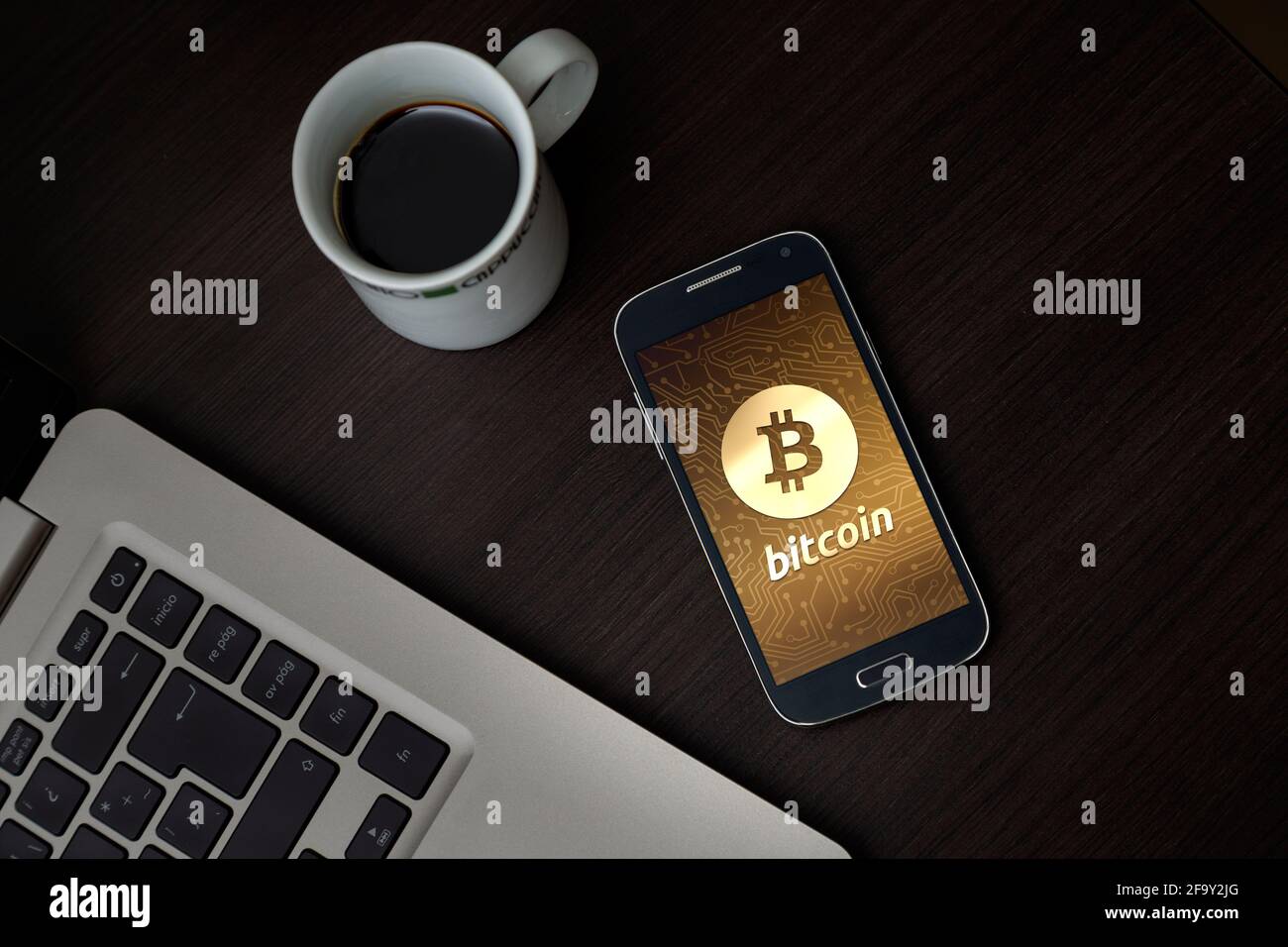 Bitcoin symbol on mobile smartphone app screen with golden circuit ...