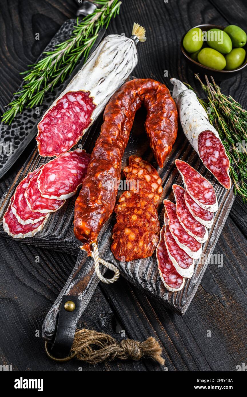 Spanish tapas sliced sausages salami, fuet and chorizo on a wooden ...