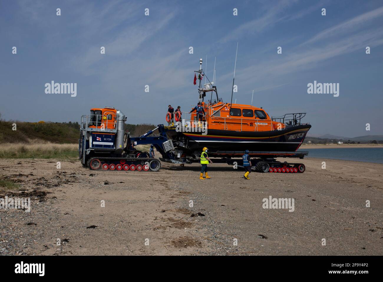 RNLI Shannon class lifeboat being transported by trailer on the beach ...
