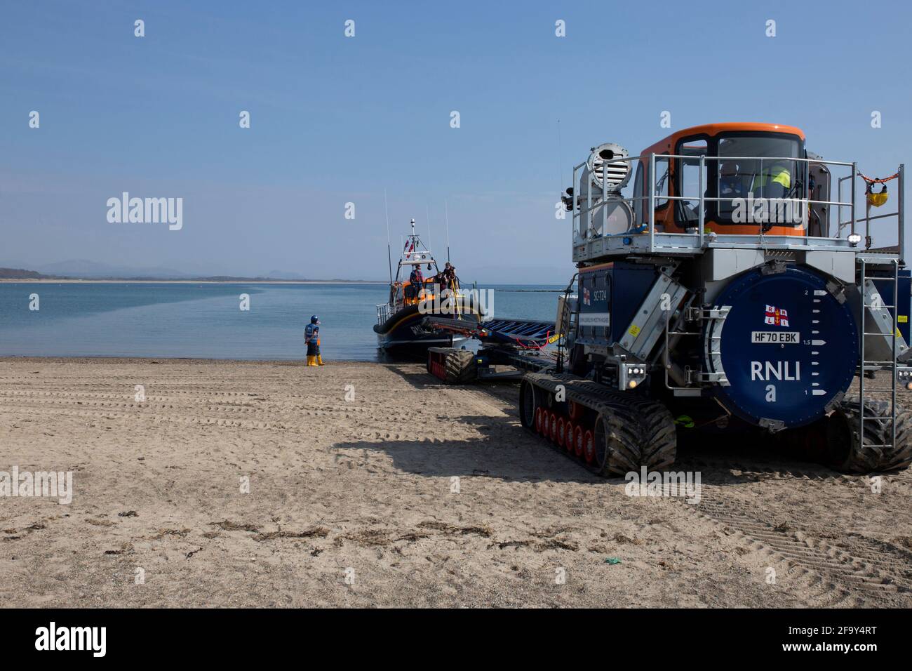 RNLI Shannon class lifeboat being loaded back onto trailer on the beach ...