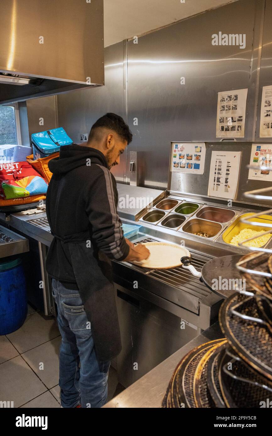 Building a pizza in a restaurant Stock Photo - Alamy