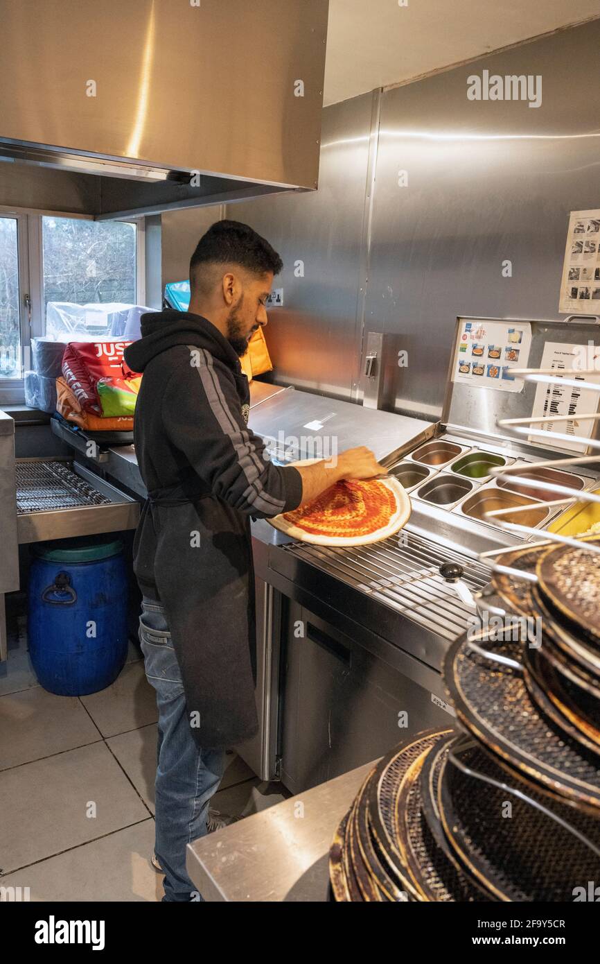 Building a pizza in a restaurant Stock Photo - Alamy