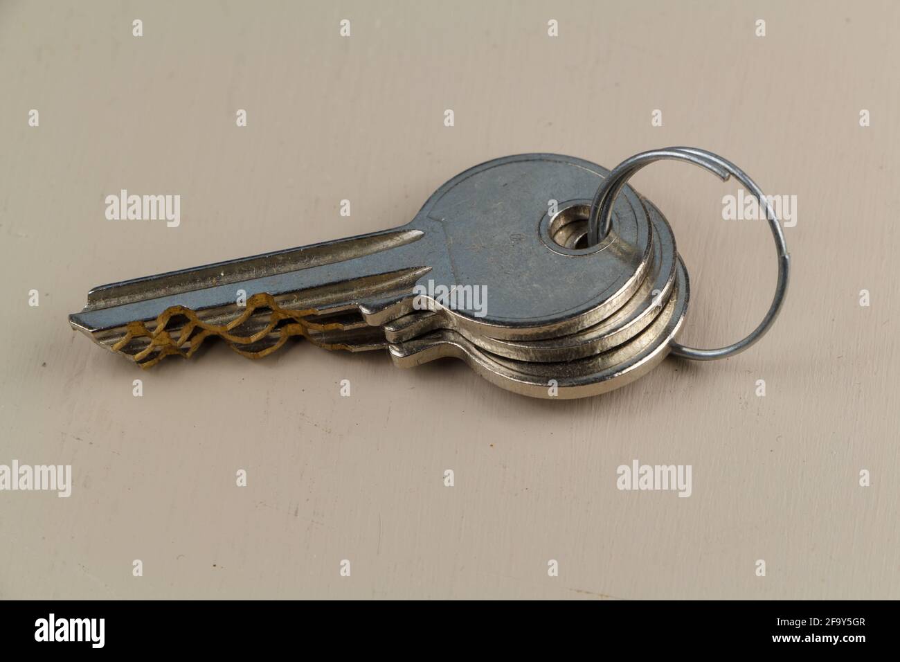 Bunch of three keys on a table Stock Photo - Alamy