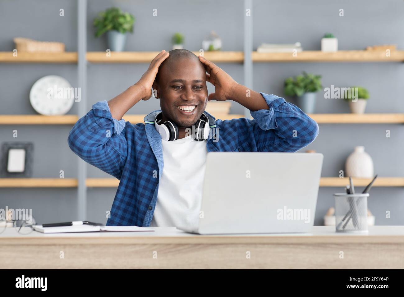 Surprised african man laptop in hi-res stock photography and images - Alamy