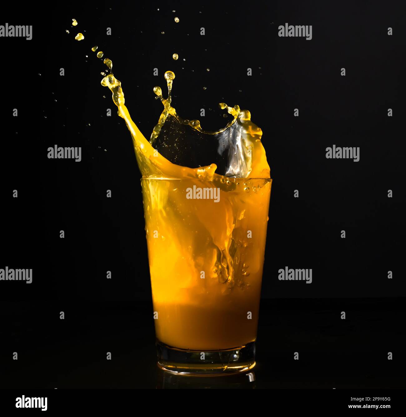 orange juice splash in glass Stock Photo - Alamy