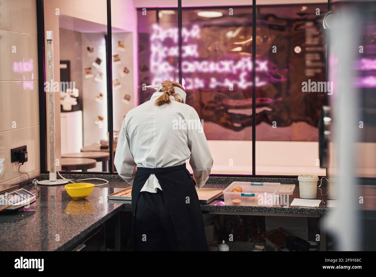 Concentrated female chef working hard in well-equipped kitchen Stock ...
