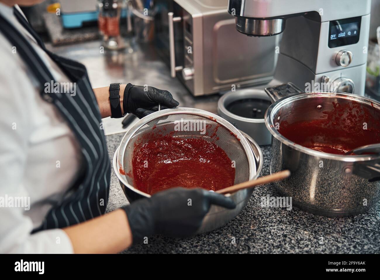 Enthusiastic chef working on batch of delicious jam Stock Photo - Alamy