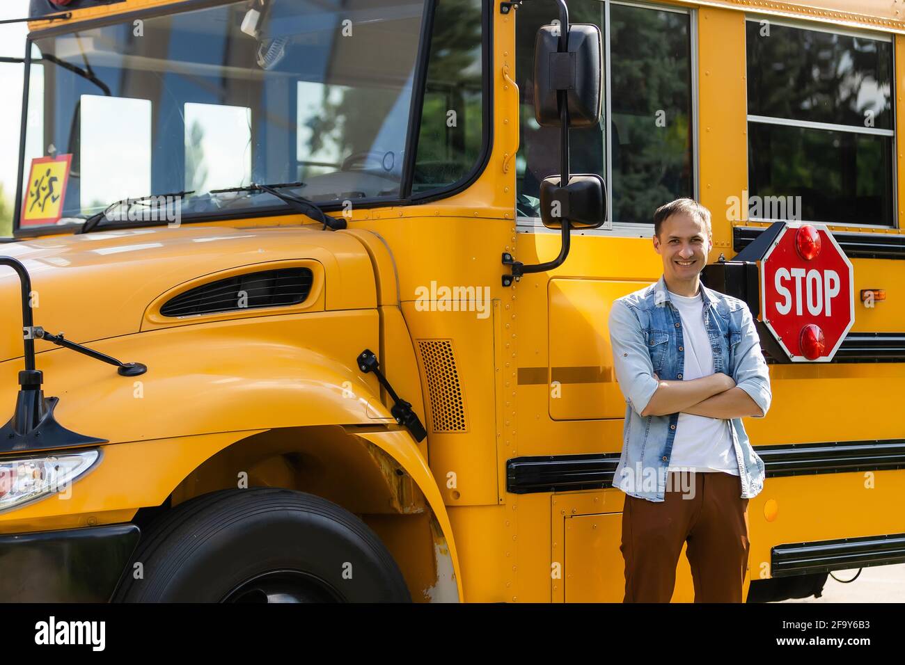 Male driver standing in front of bus Stock Photo - Alamy