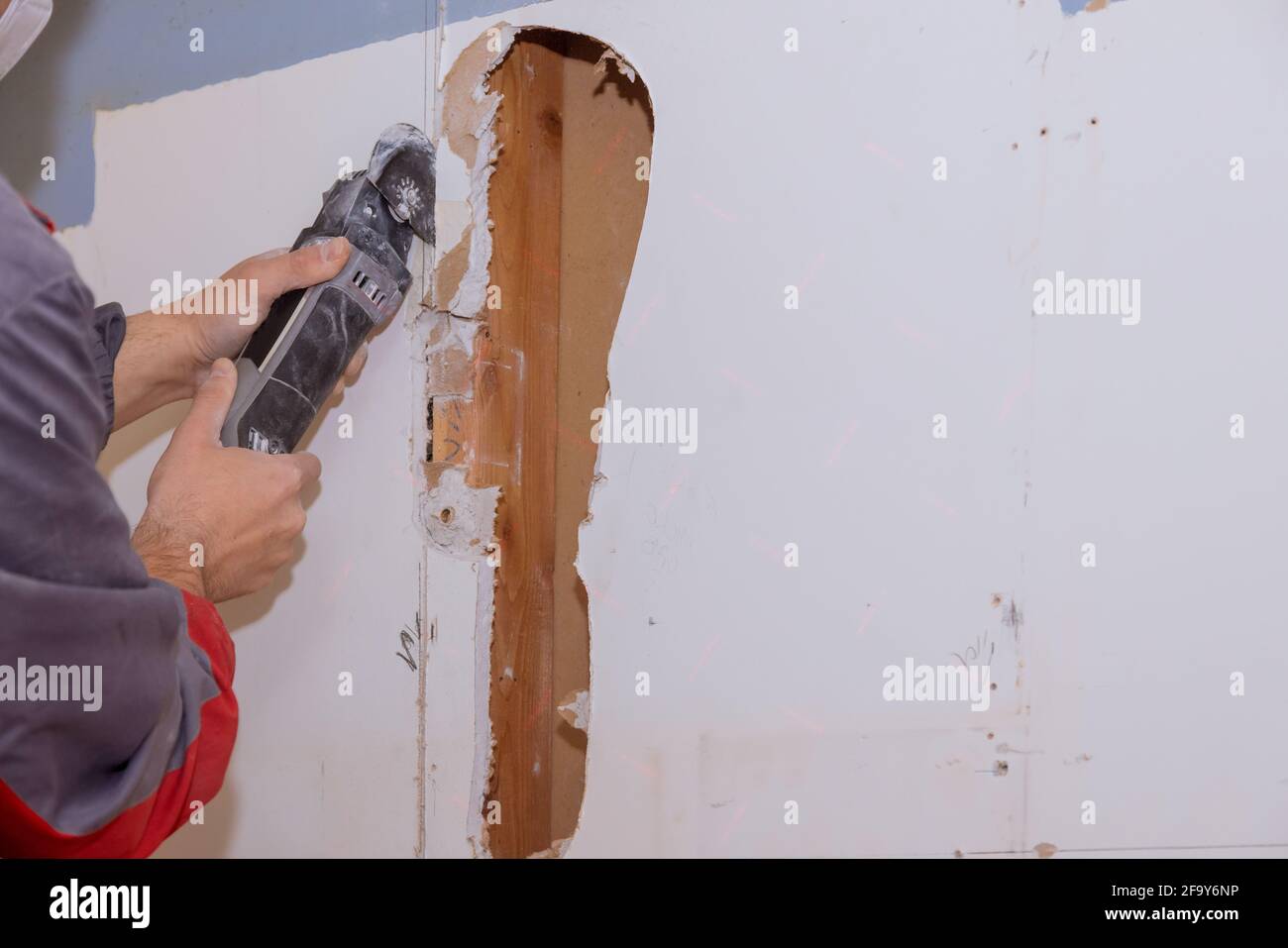 Home Interior damage for drywall board with repair home of man cutting ...